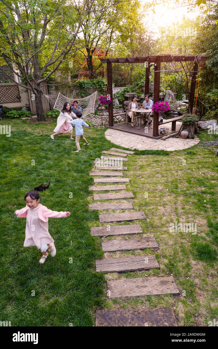 Happy family playing in the courtyard Stock Photo - Alamy