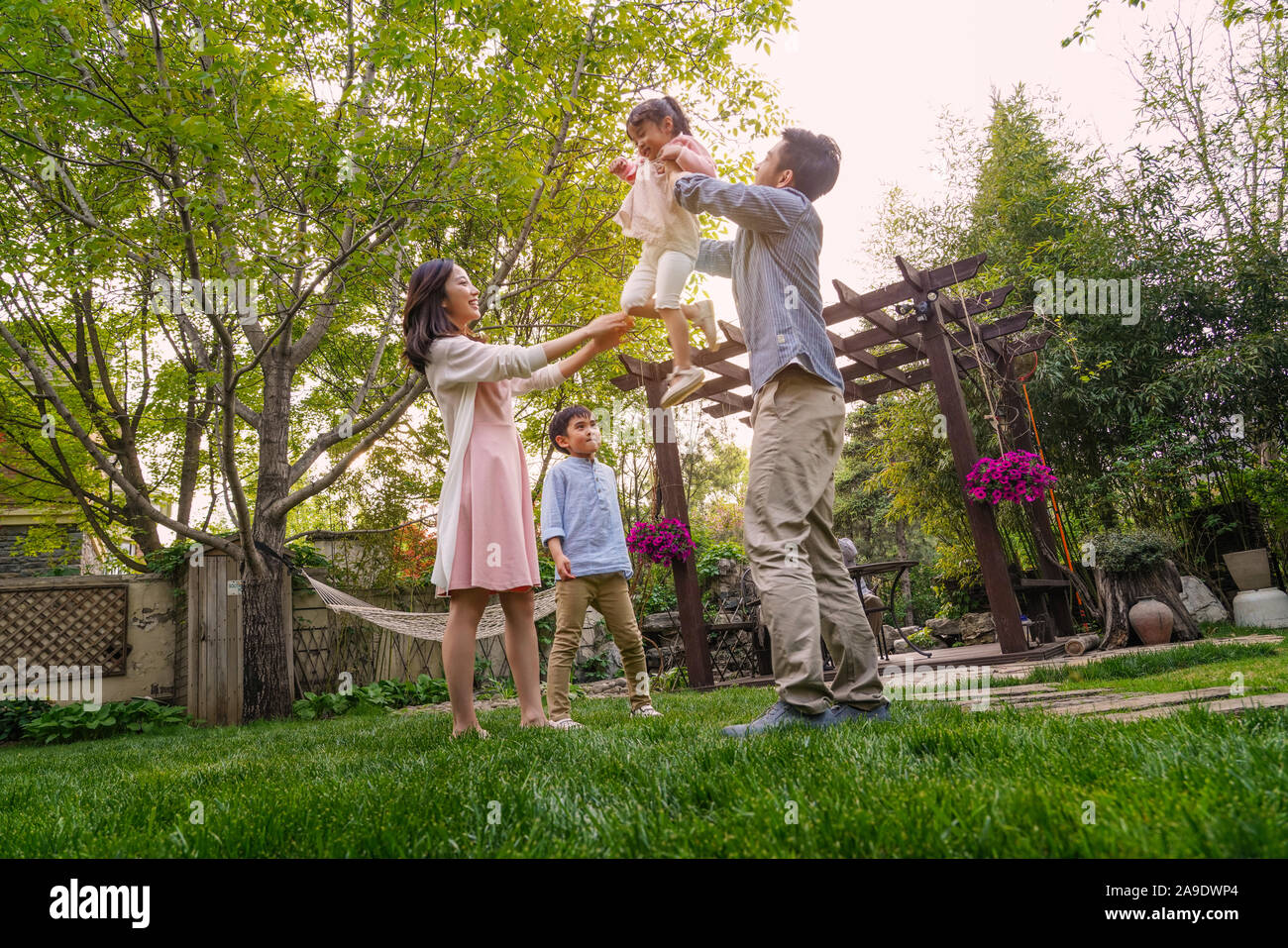 Happy family playing in the courtyard Stock Photo - Alamy