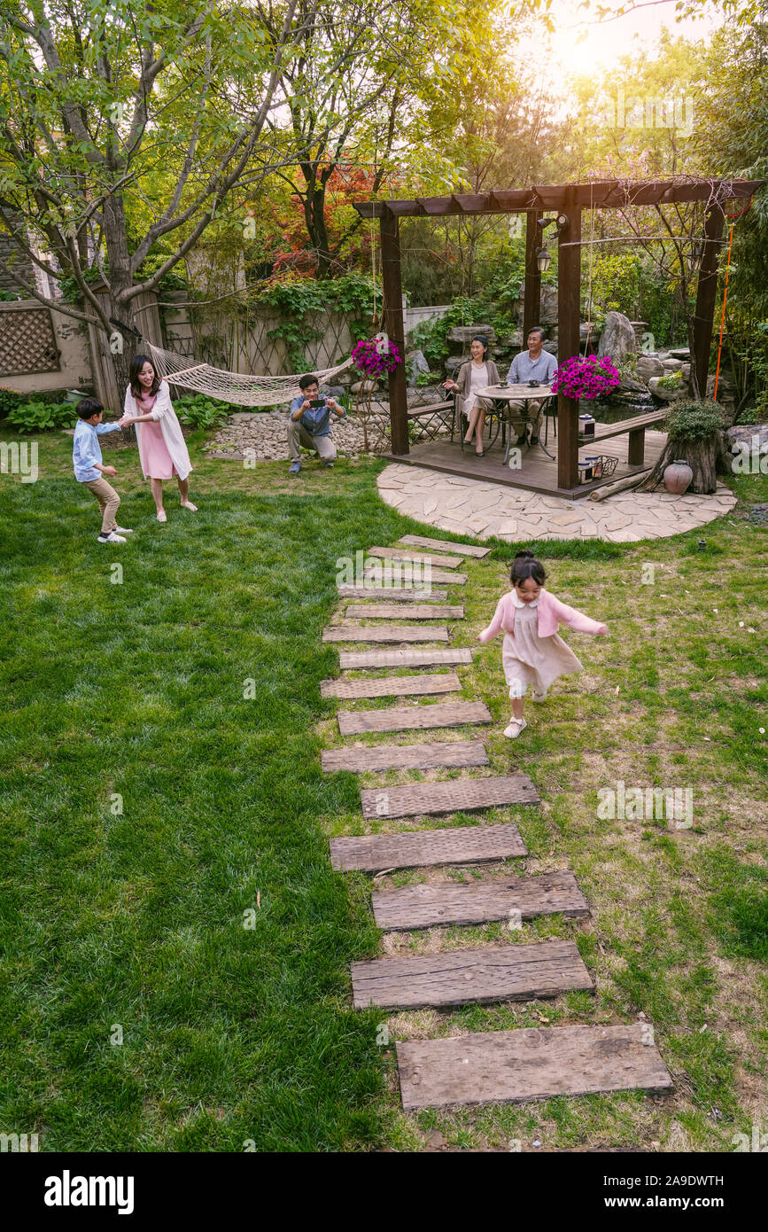 Happy family playing in the courtyard Stock Photo - Alamy