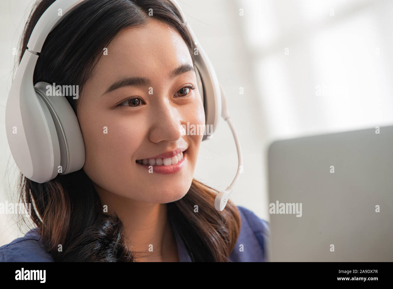 Young women wearing headphones Stock Photo - Alamy