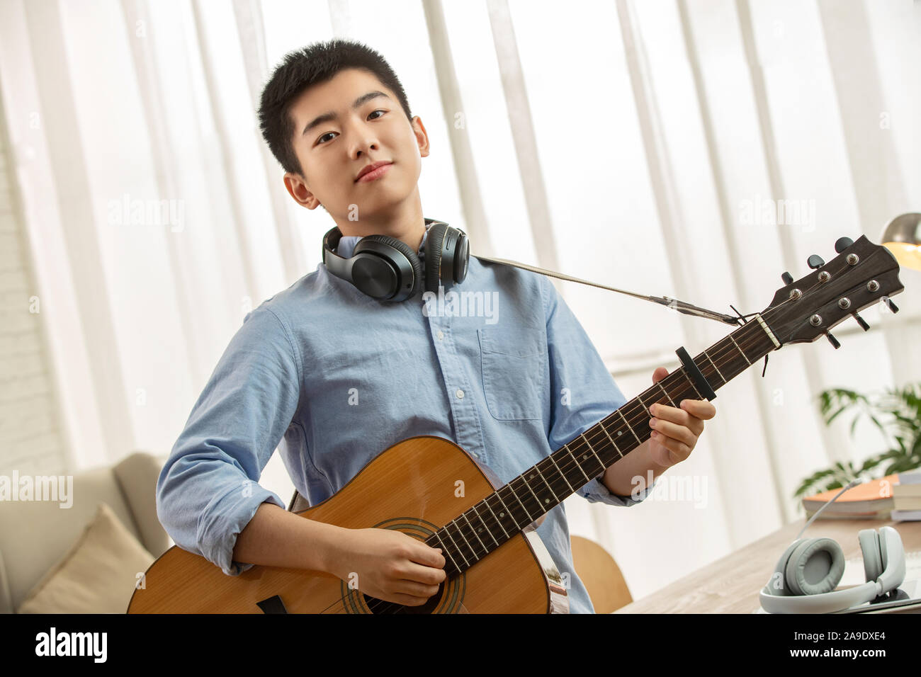 Happy boy playing the guitar Stock Photo - Alamy