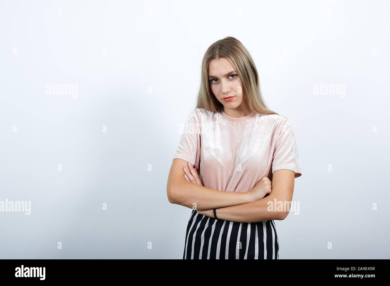 Side view of woman hugging herself with opened eyes over isolated on ...