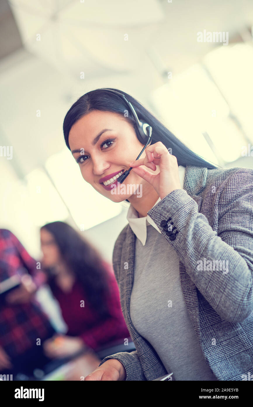 Beautiful call center agent browsing the internet on her computer Stock ...