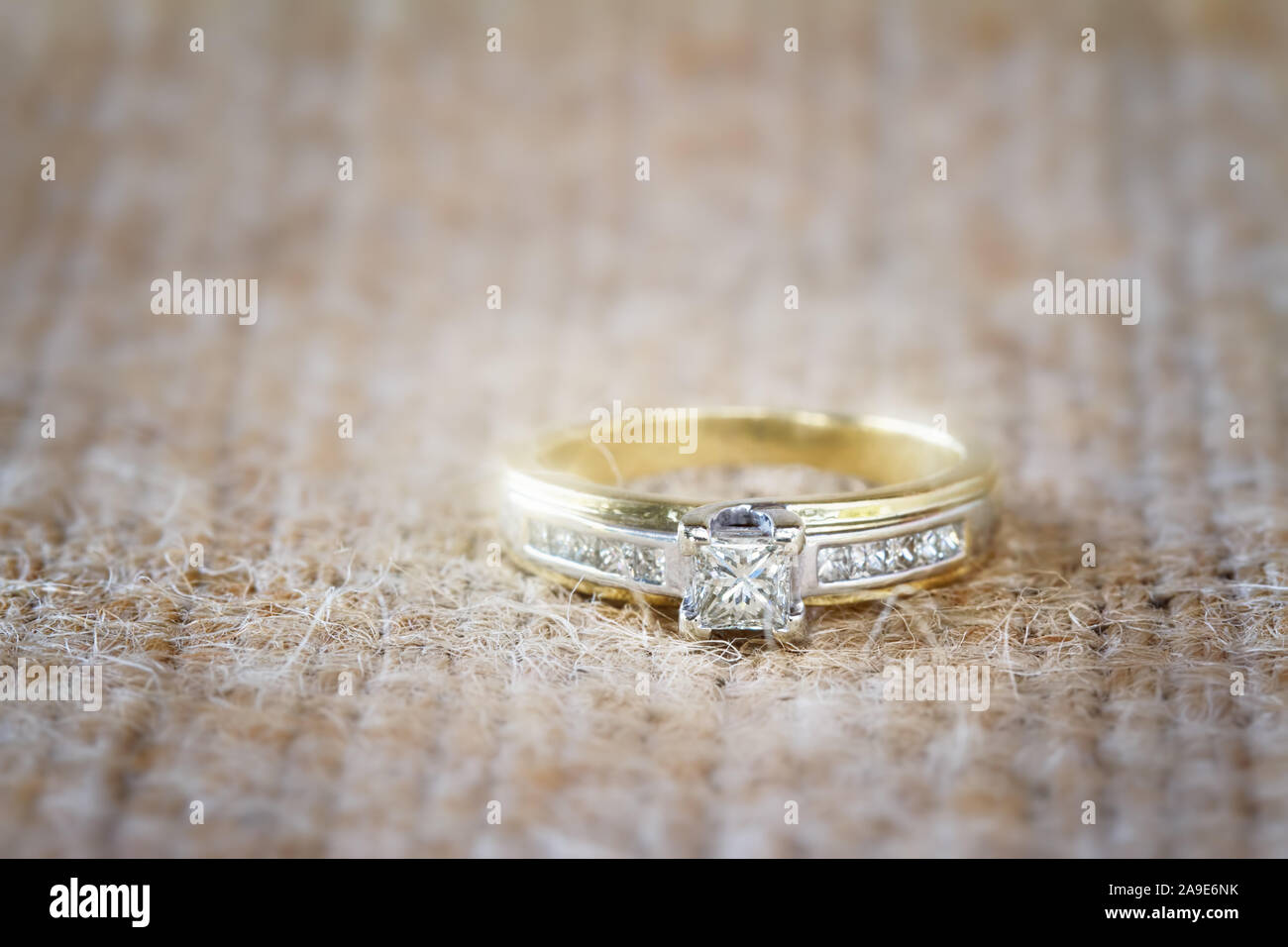 Diamond engagement ring on a textured surface Stock Photo - Alamy