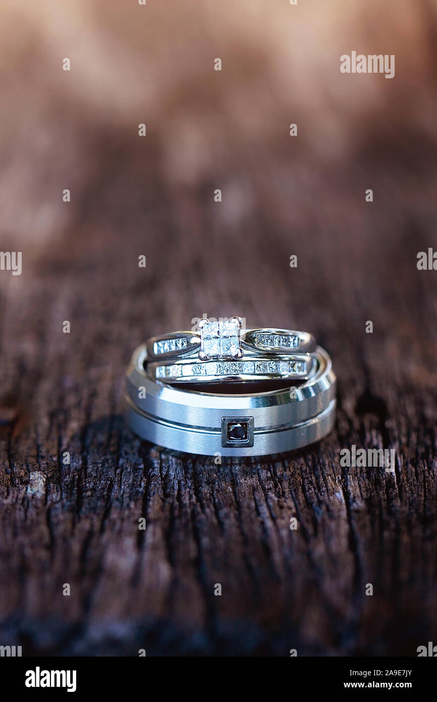 Wedding rings stacked on timber Stock Photo - Alamy