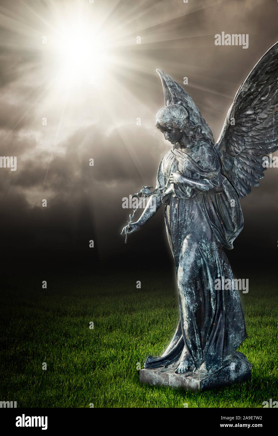 A photography of a religious angel under a dark sky Stock Photo - Alamy
