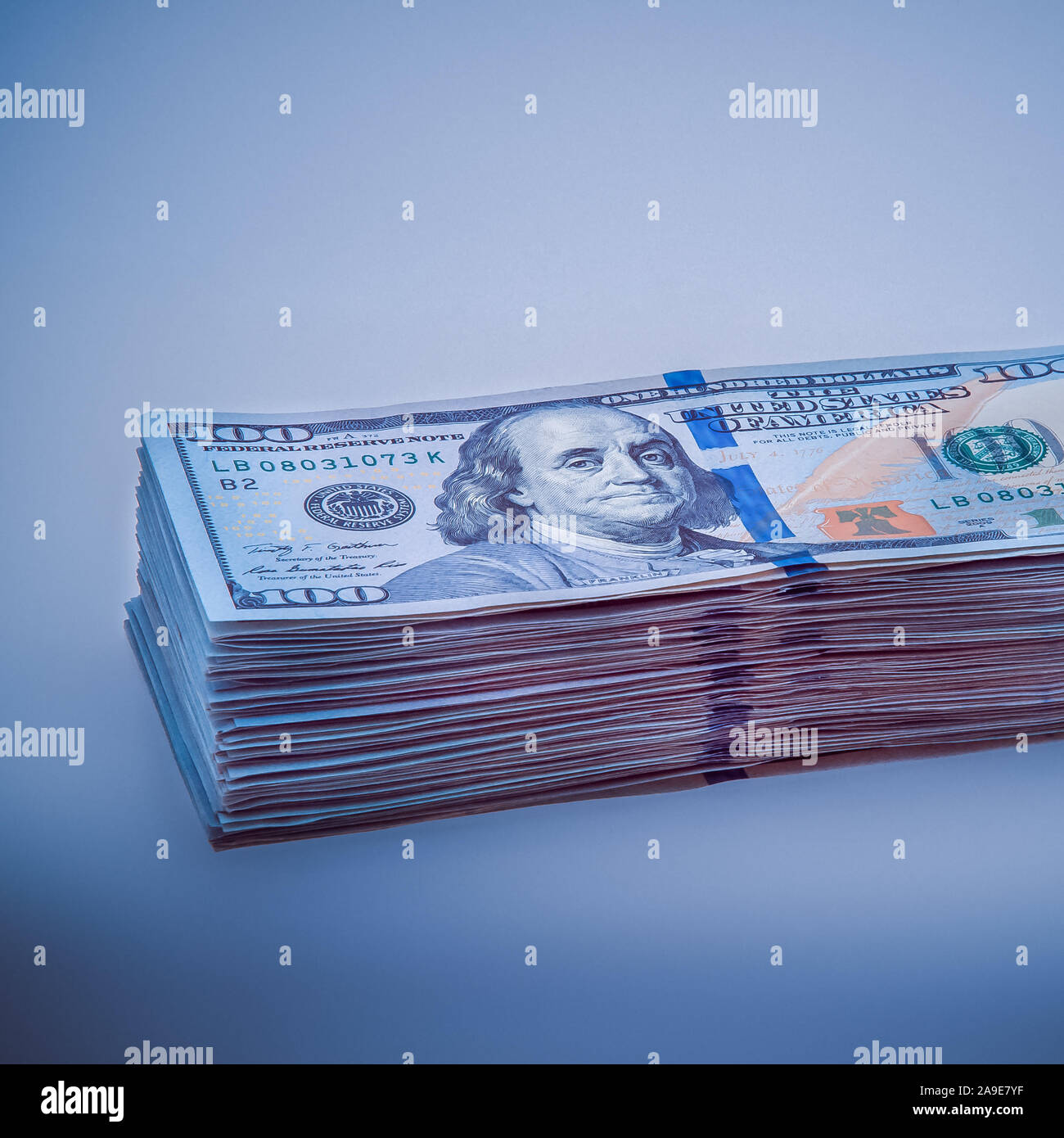 A big stack of hundred-dollar bills. Blue design. Vignetting Stock ...