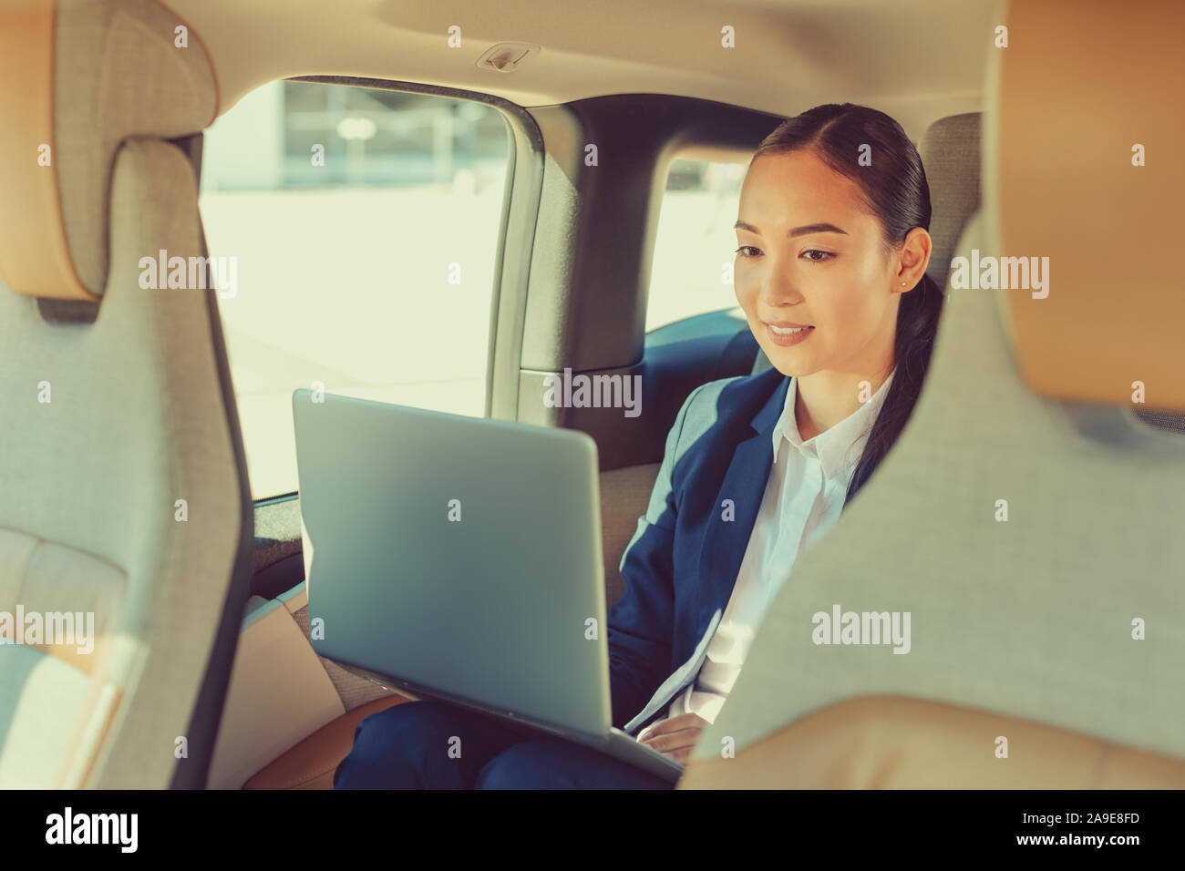 Attentive young female staring at screen of laptop Stock Photo - Alamy