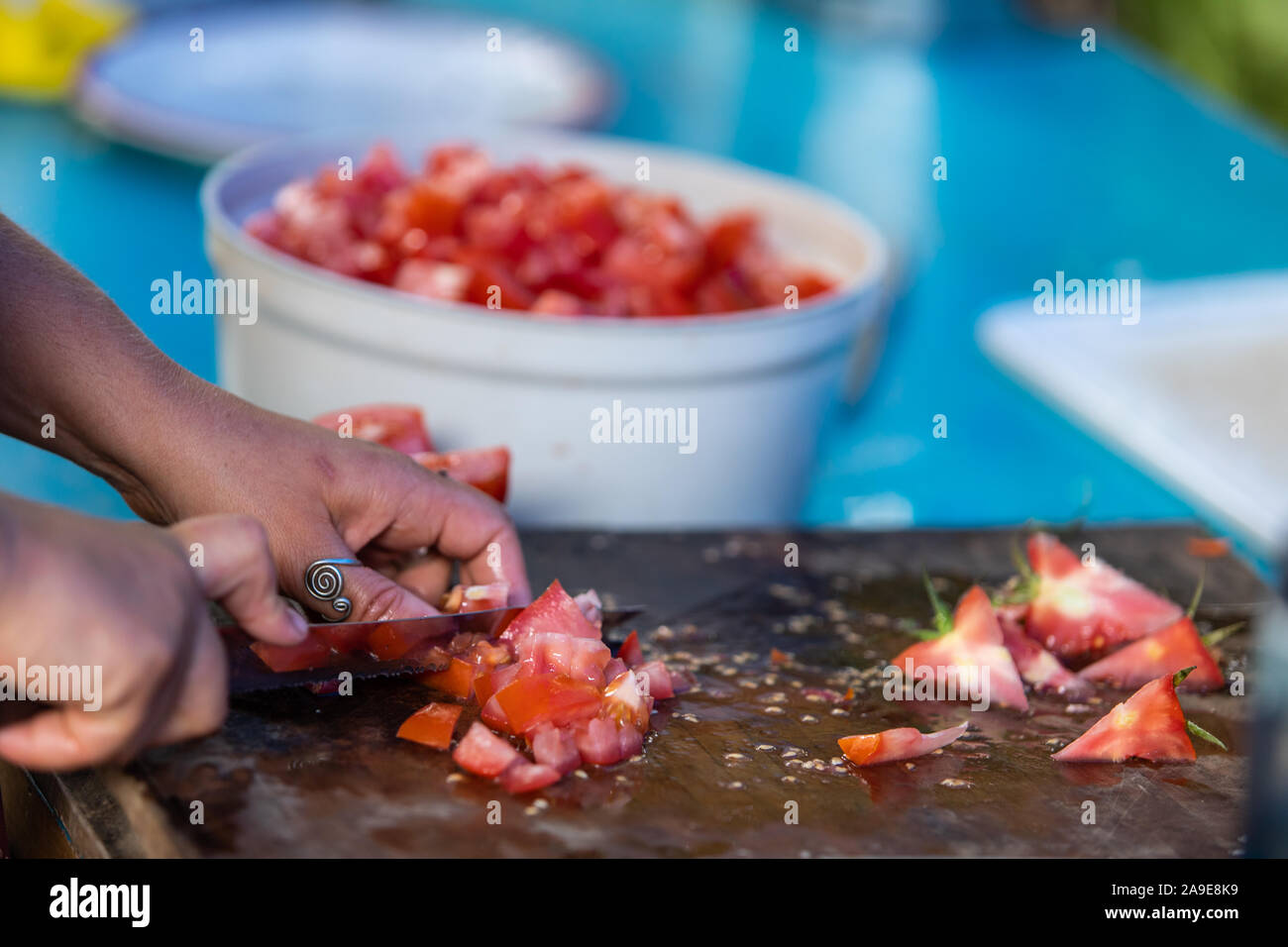 Person chops fresh vegetables outdoor, A Selective focus closeup view ...