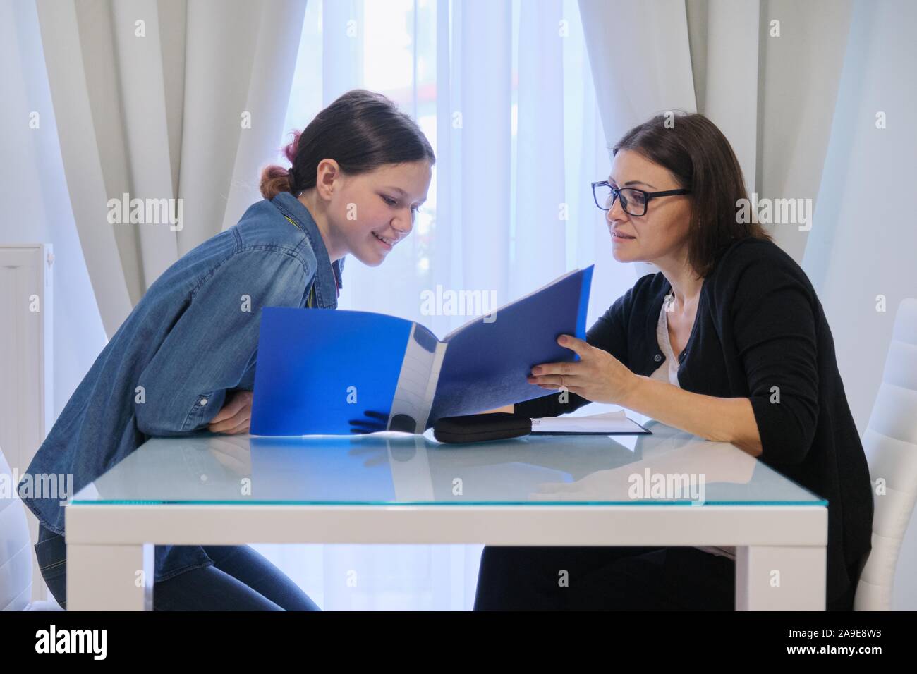 Female teacher teaching teenage girl individually, private lessons ...