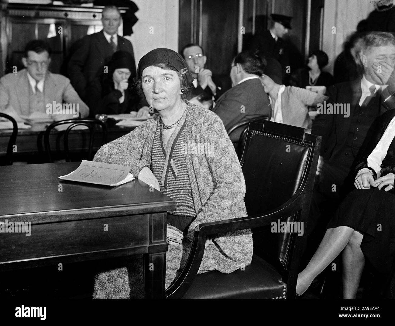 Margaret Sanger, proponent of the eugenics movement, sitting at a ...