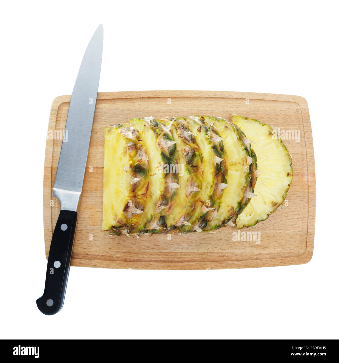 Fresh pineapple slices on brown chopping board Stock Photo - Alamy