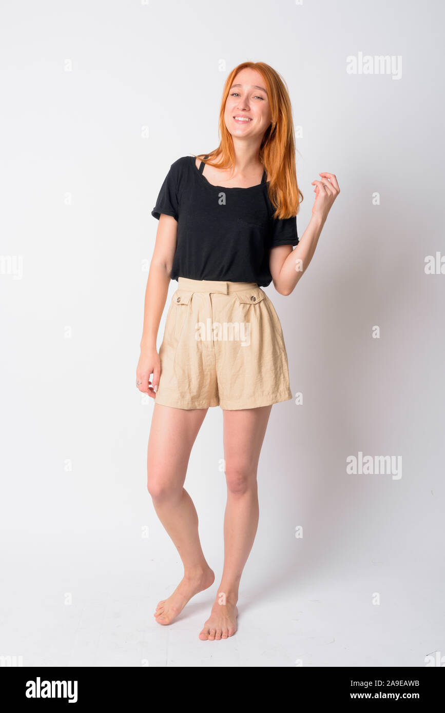 Full body shot of happy young beautiful redhead woman smiling Stock ...