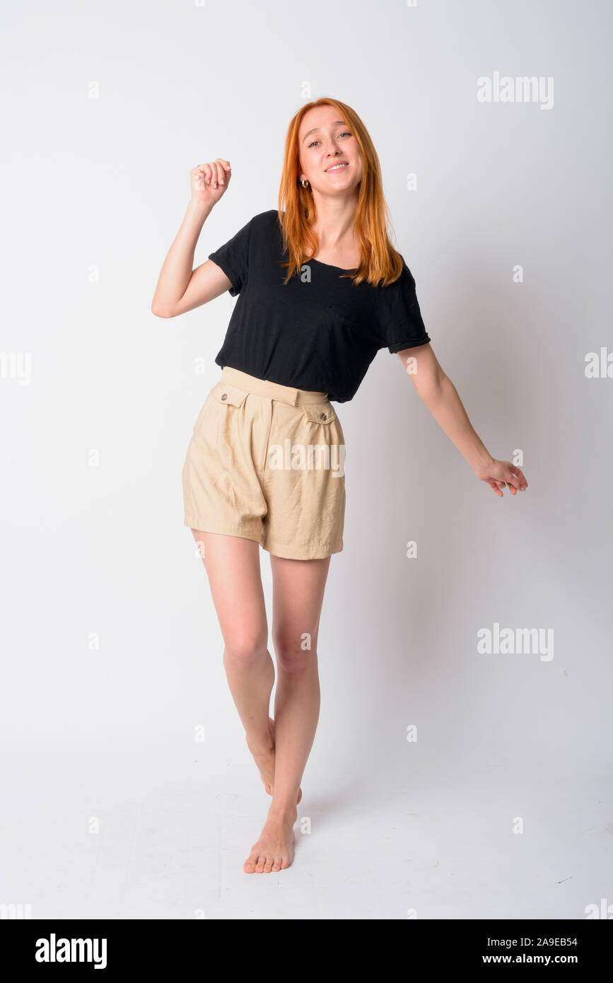 Full body shot of happy young beautiful redhead woman smiling Stock ...