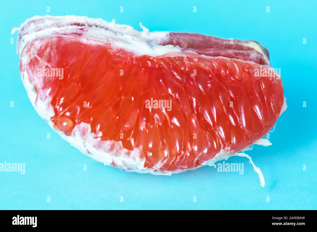 Orange slices with red flesh on a blue background Stock Photo - Alamy