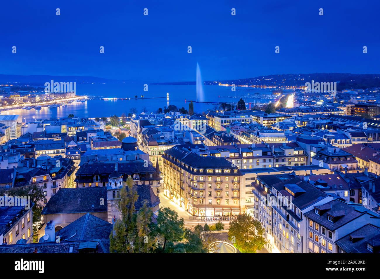 Aerial view of Geneva City center and Jet d'eau by night. This photo ...