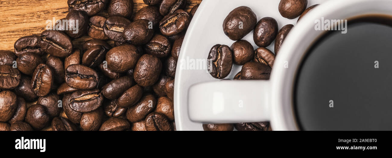 Coffee bean. On the background of wooden boards a cup of coffee and ...