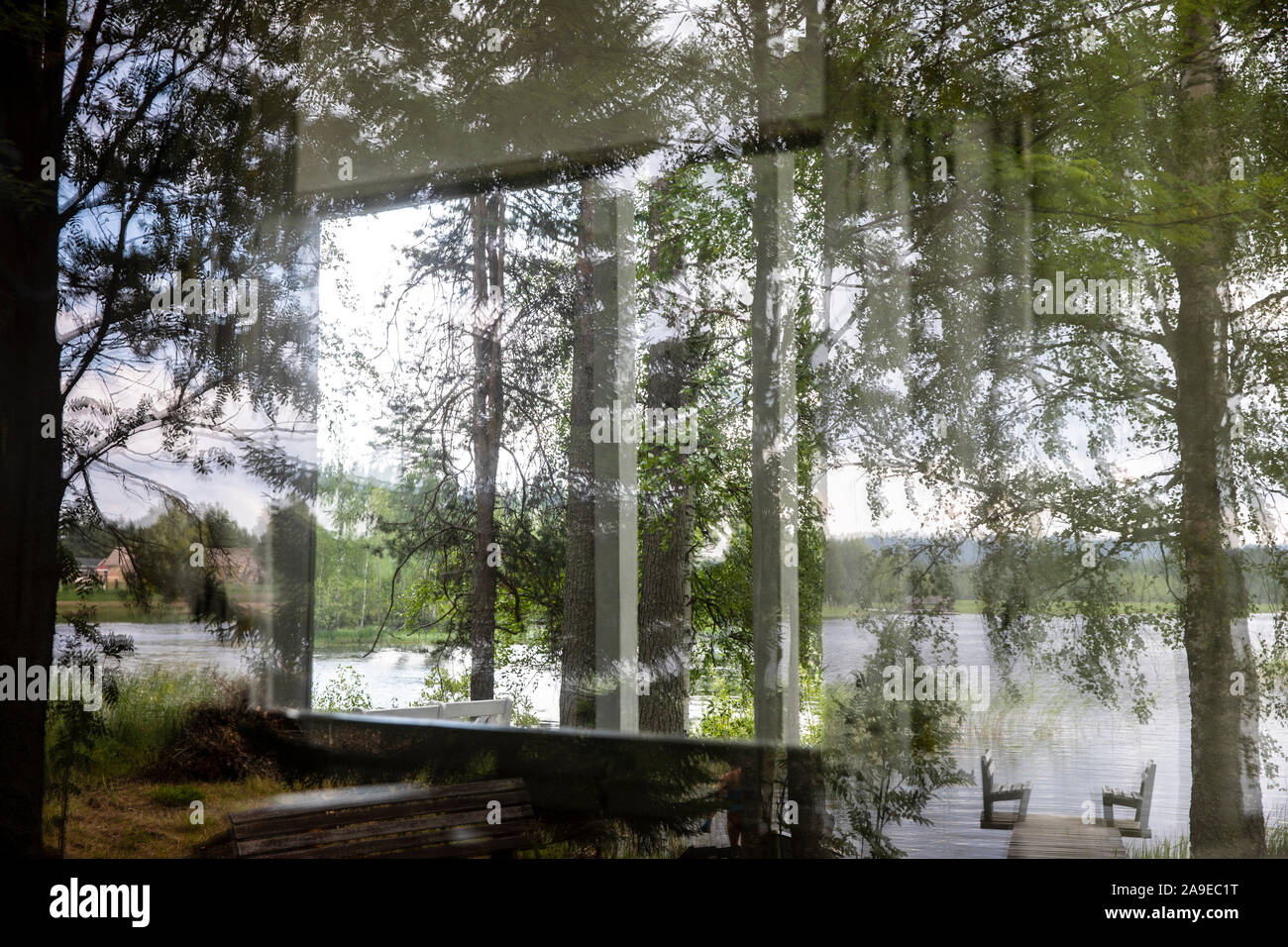 Finland, Central finland, mirroring in window of a summer house in ...