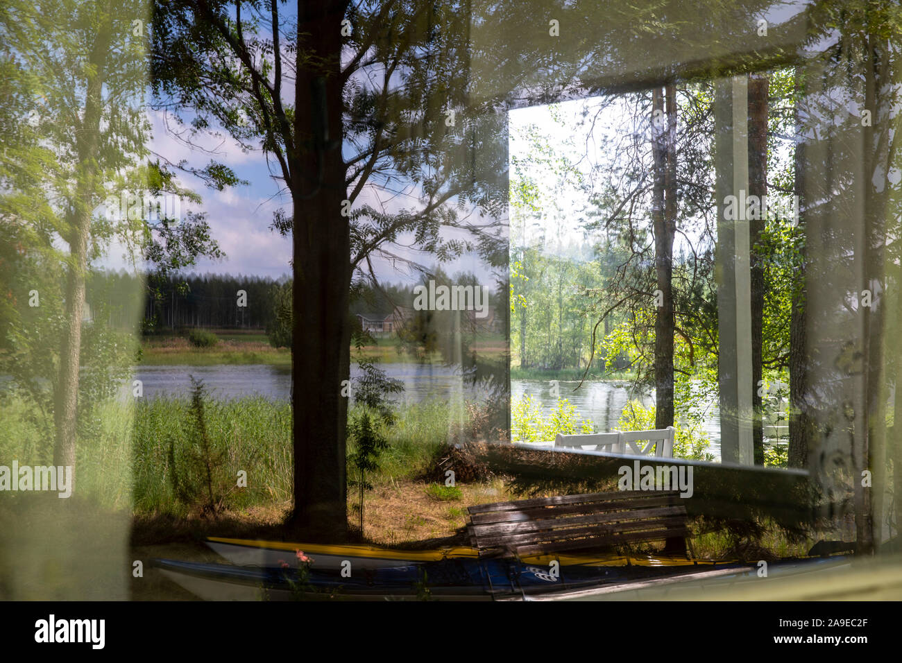 Finland, Central finland, mirroring in window of a summer house in ...