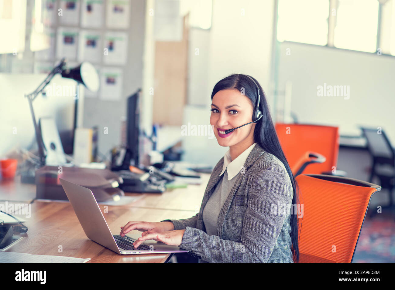 Beautiful call center agent browsing the internet on her computer Stock ...