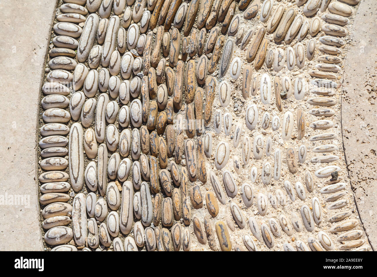 A round mosaic sample from stones or pebbles, medium close-up ...