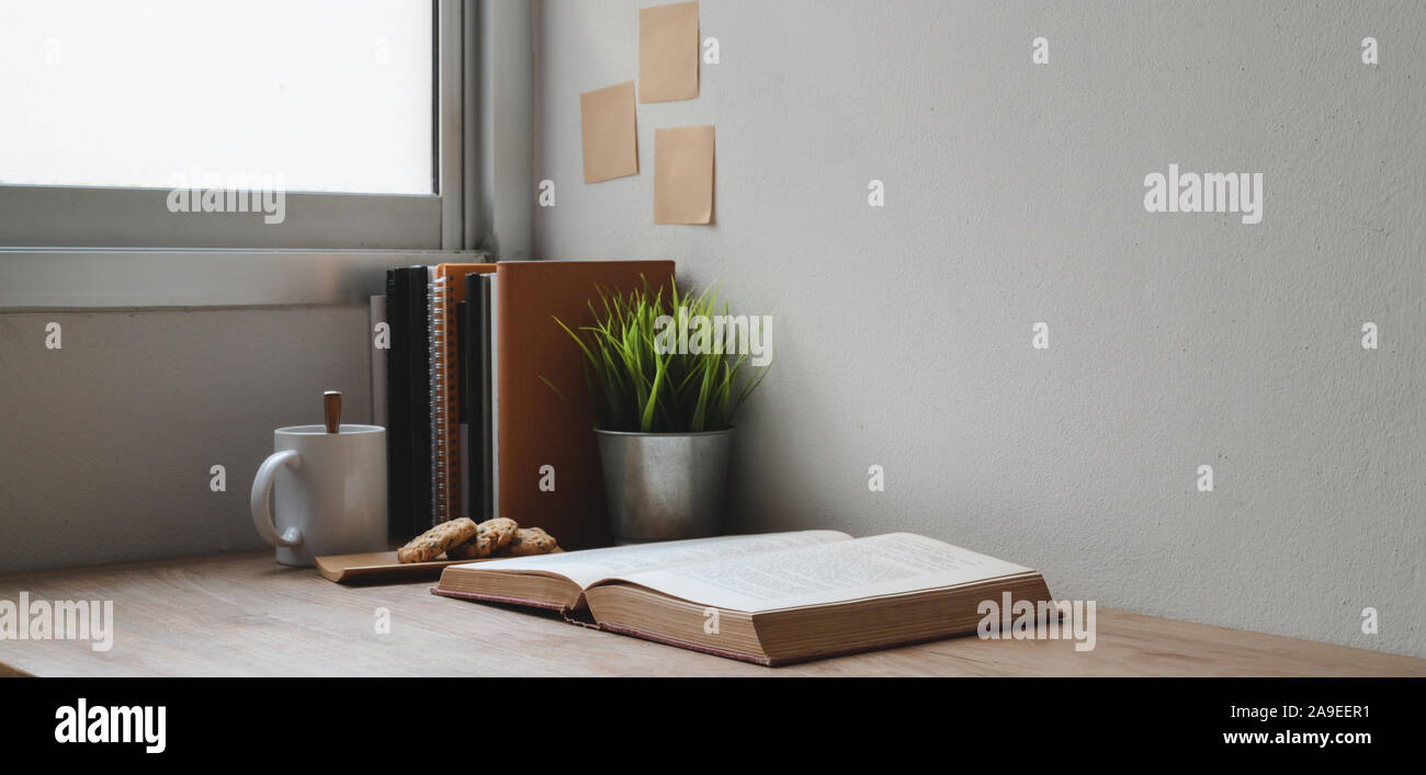 Cropped shot of comfortable workplace with books and office supplies on ...