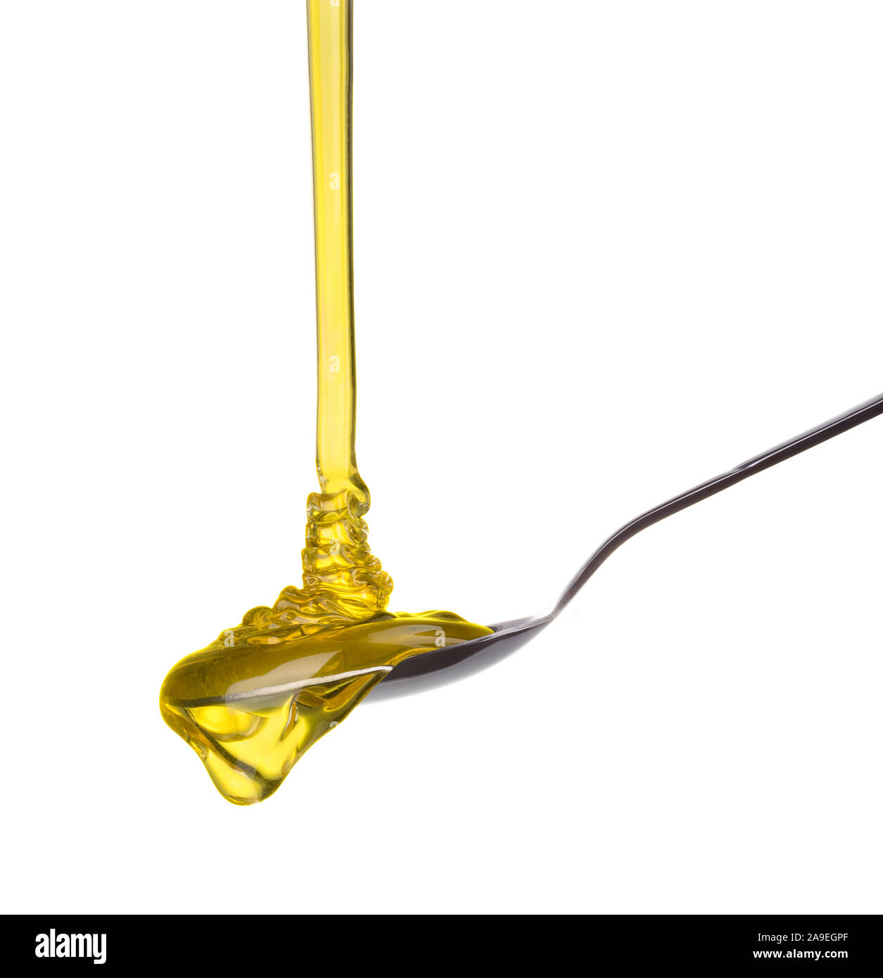Falling and flowing honey on a spoon isolated on white with clipping ...