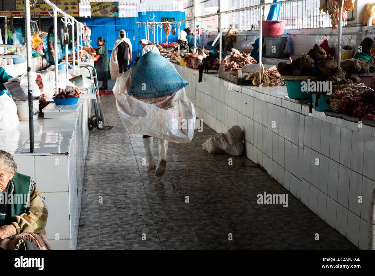 Meat bearer in closed market, Cusco, Peru Stock Photo - Alamy