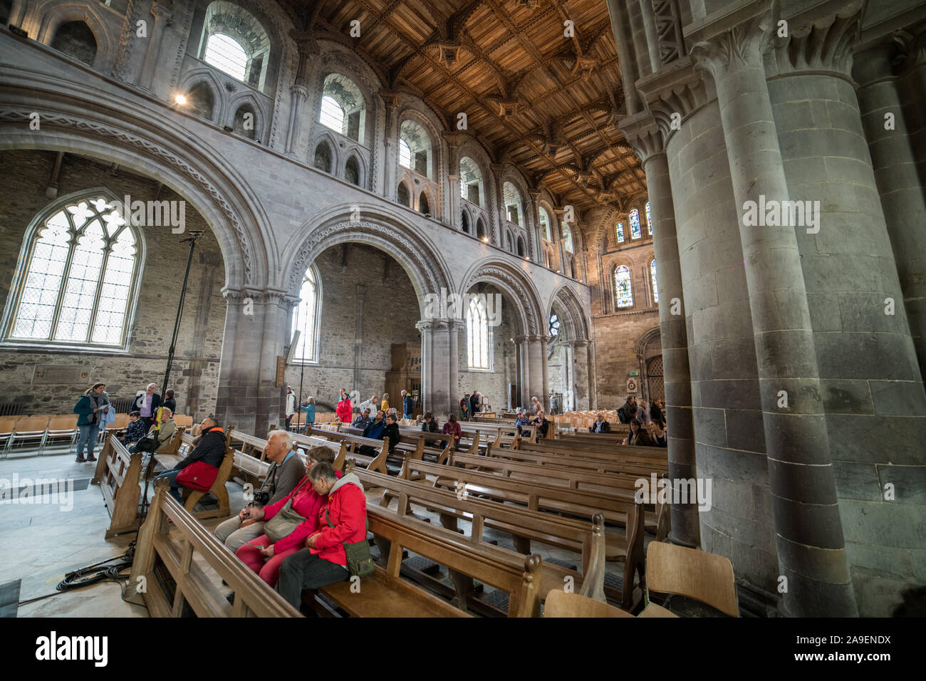 People sit inside St David's Cathedral in St Davids, Pembrokshire ...