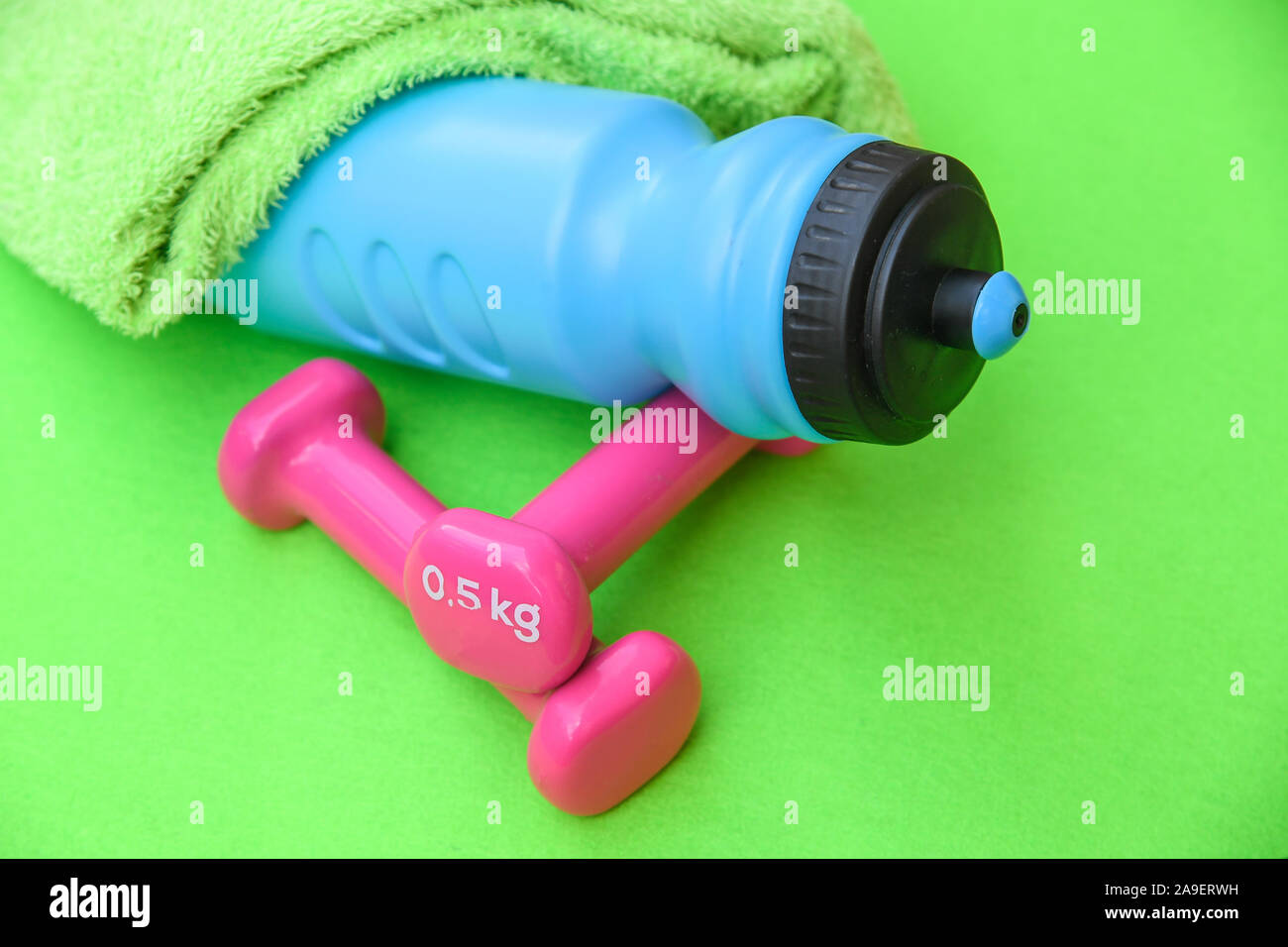 Still life view of fitness object over a colorful background. Weights ...