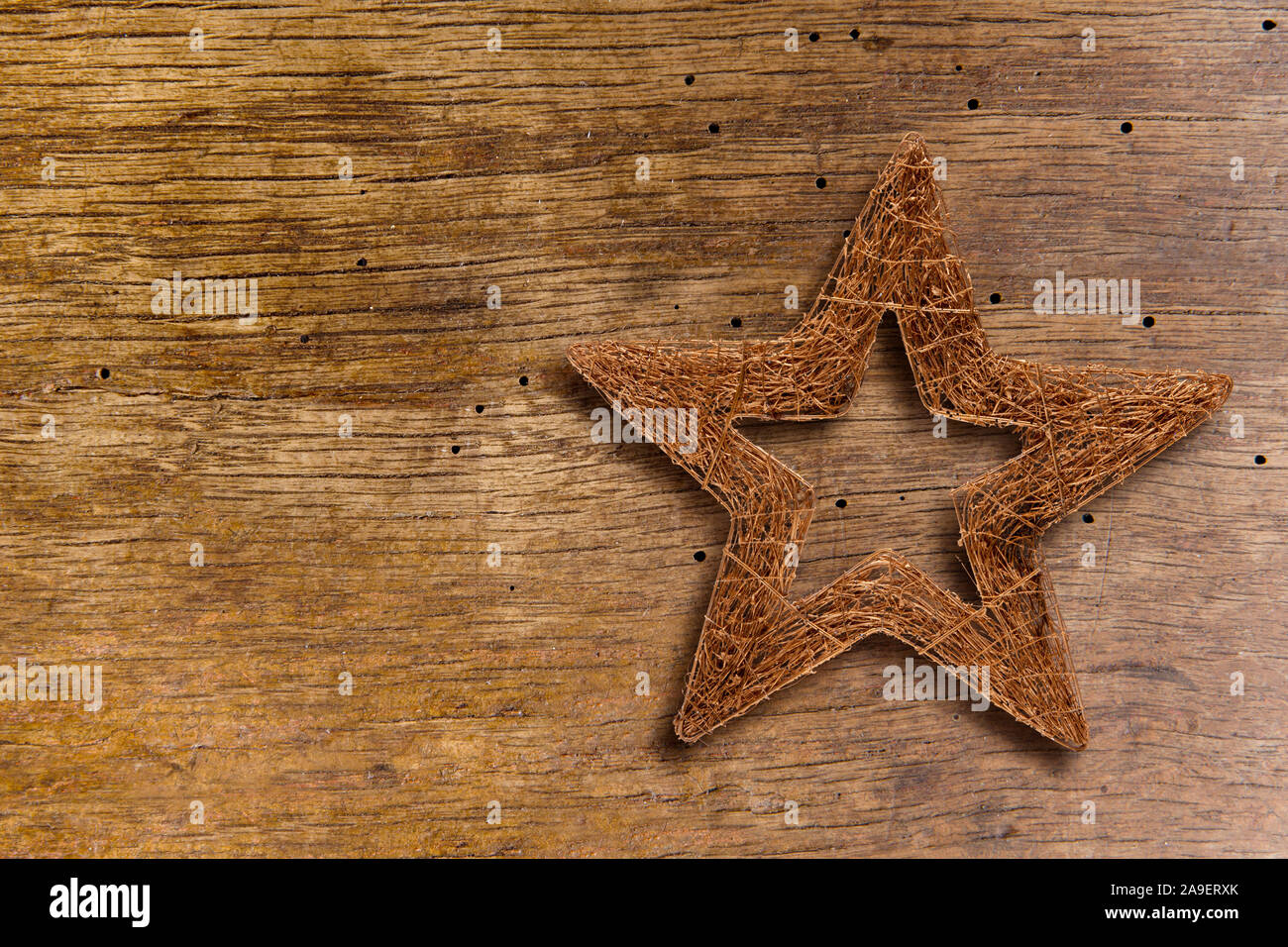 Bast star in front of wood background Stock Photo - Alamy
