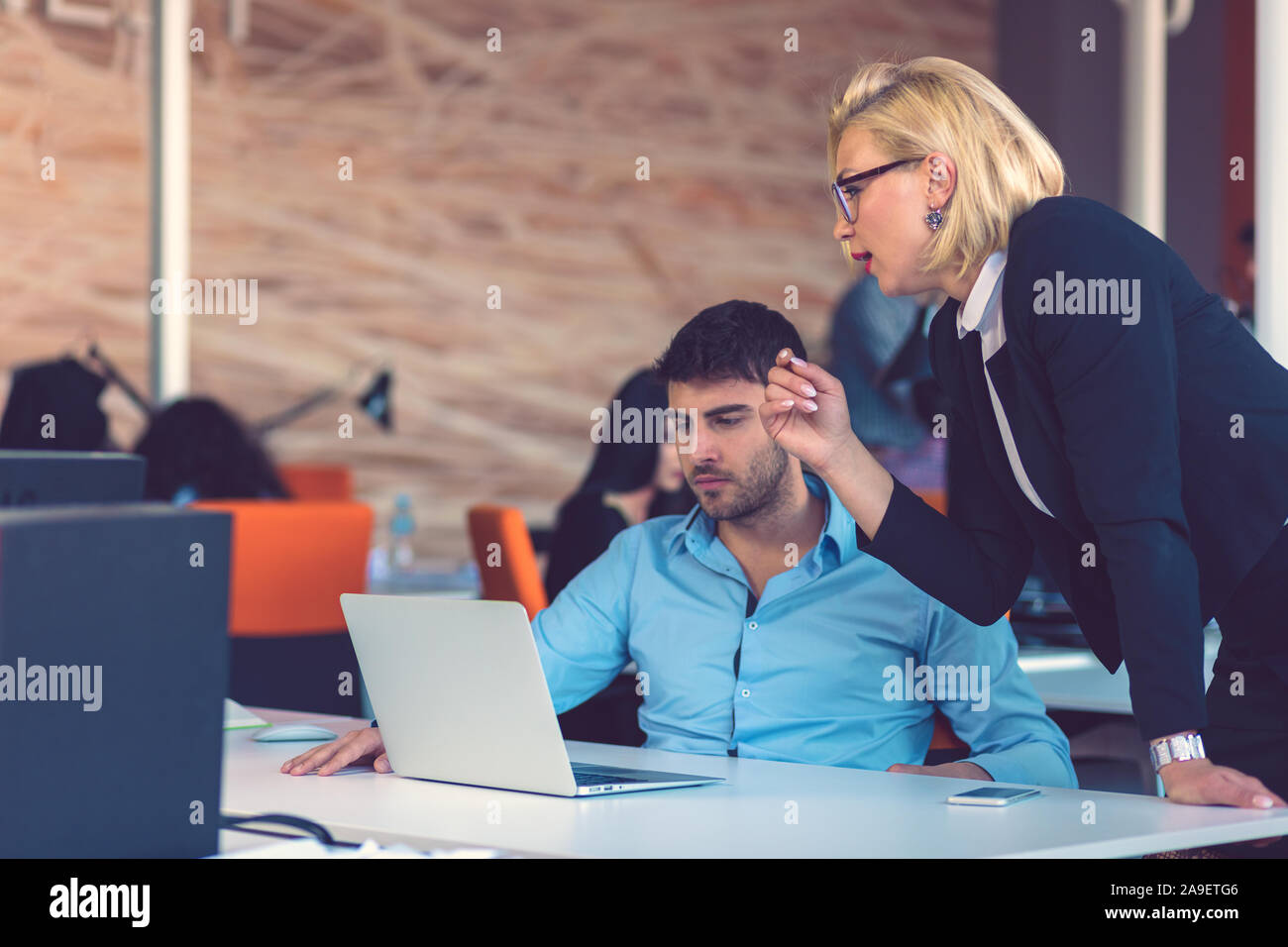 Happy business partners working on laptop. Teamwork, co-working ...