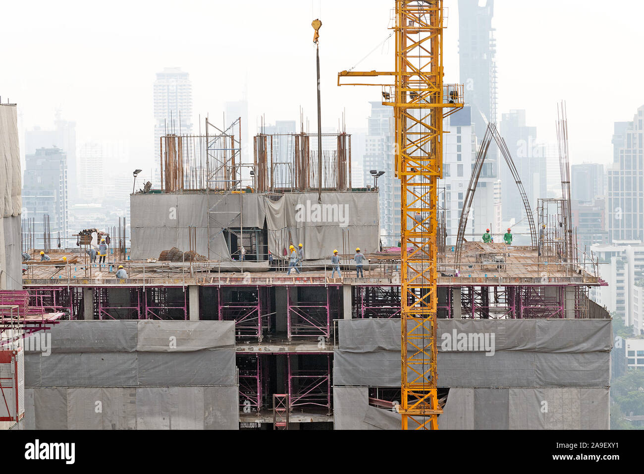 Aerial view of a building construction with tower crane, scaffolding ...