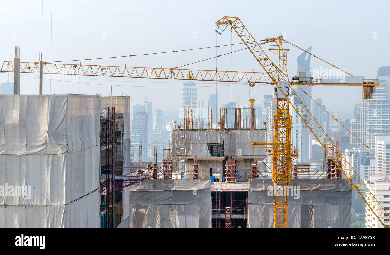 Aerial view of a building construction with tower crane, scaffolding ...