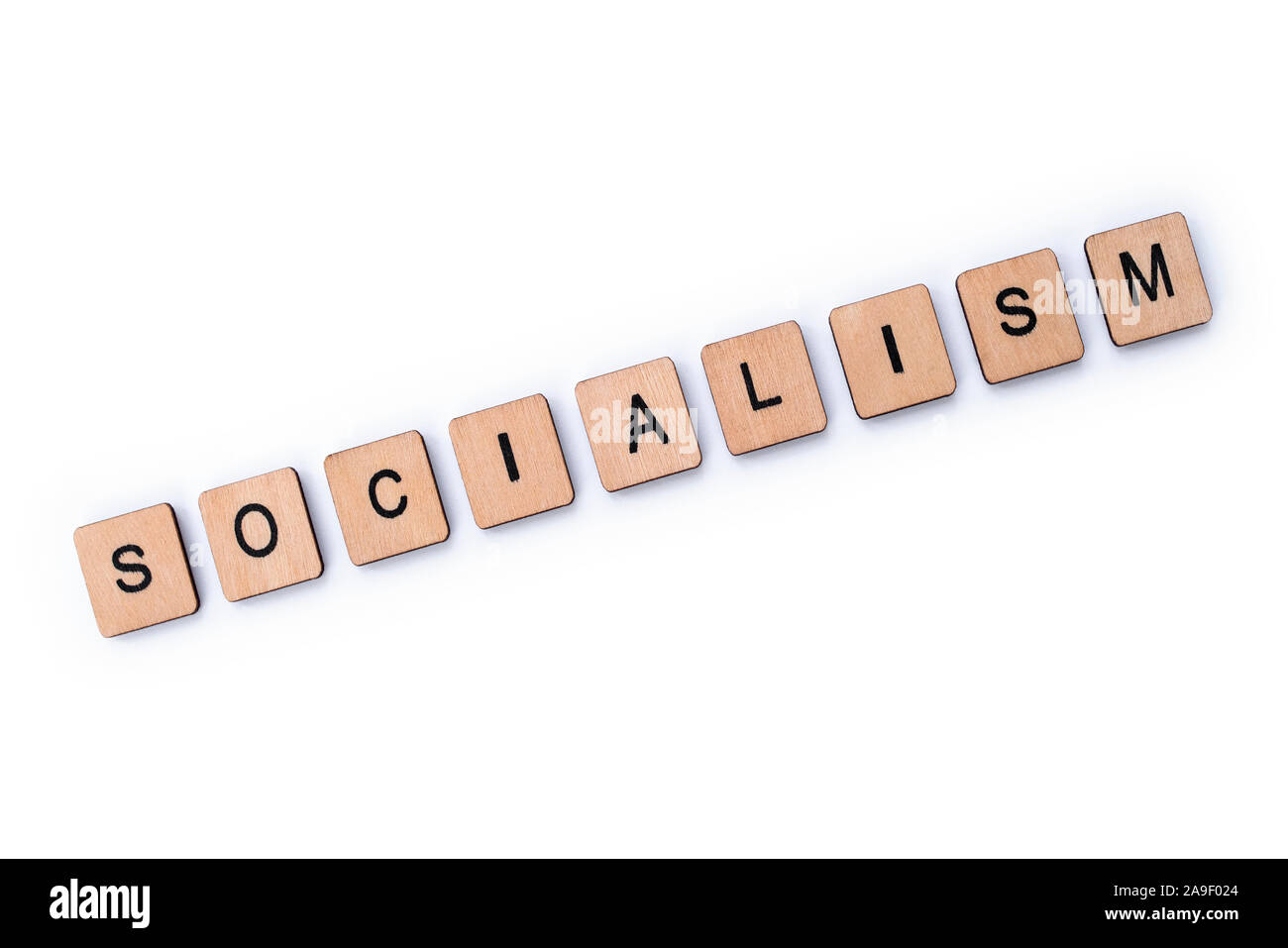 The word SOCIALISM, spelt with wooden letter tiles over a plain white ...