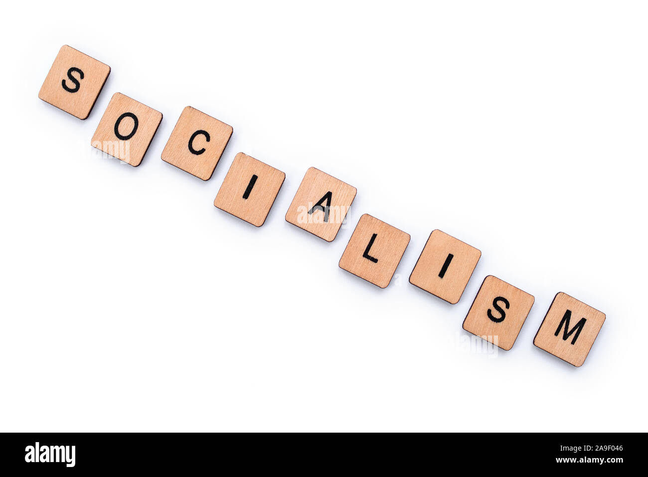 The word SOCIALISM, spelt with wooden letter tiles over a plain white ...