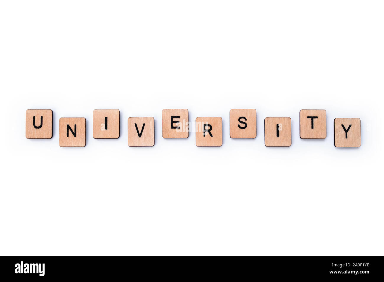 The word UNIVERSITY, spelt with wooden letter tiles on a white ...