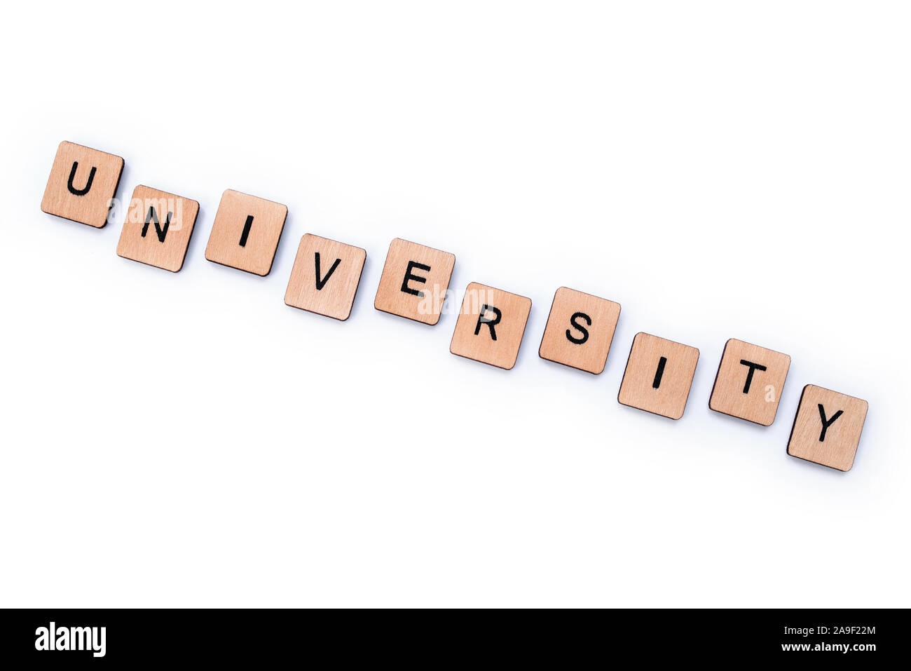 The word UNIVERSITY, spelt with wooden letter tiles on a white ...