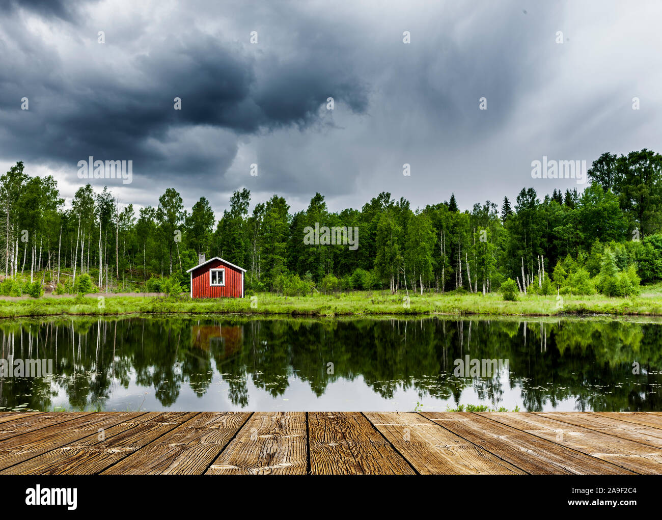 Red house at the lake Stock Photo - Alamy