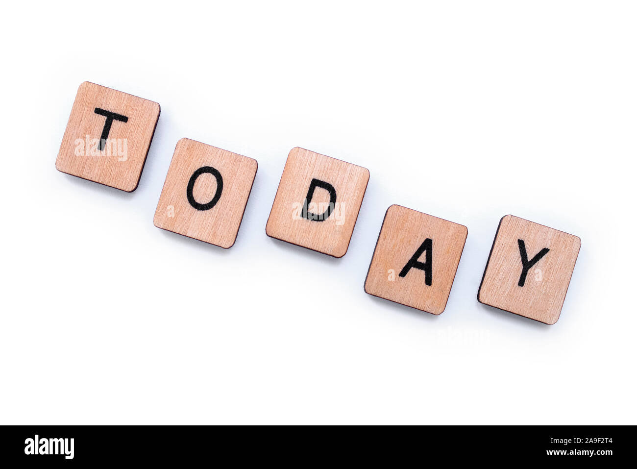The word TODAY, spelt with wooden letter tiles over a white background ...