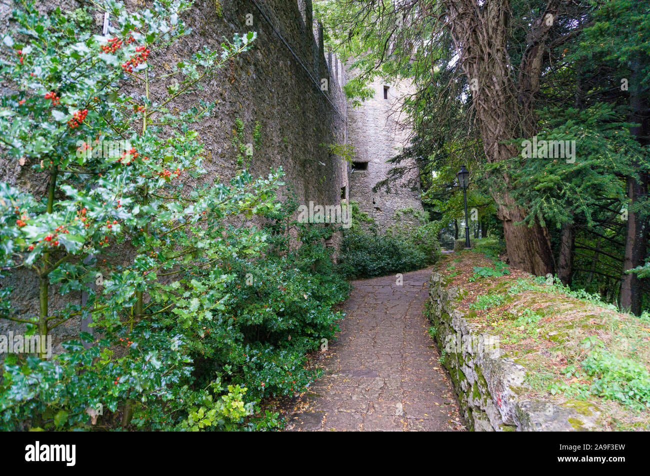 Alley walkway, path along fortified stone wall of old castle Stock ...