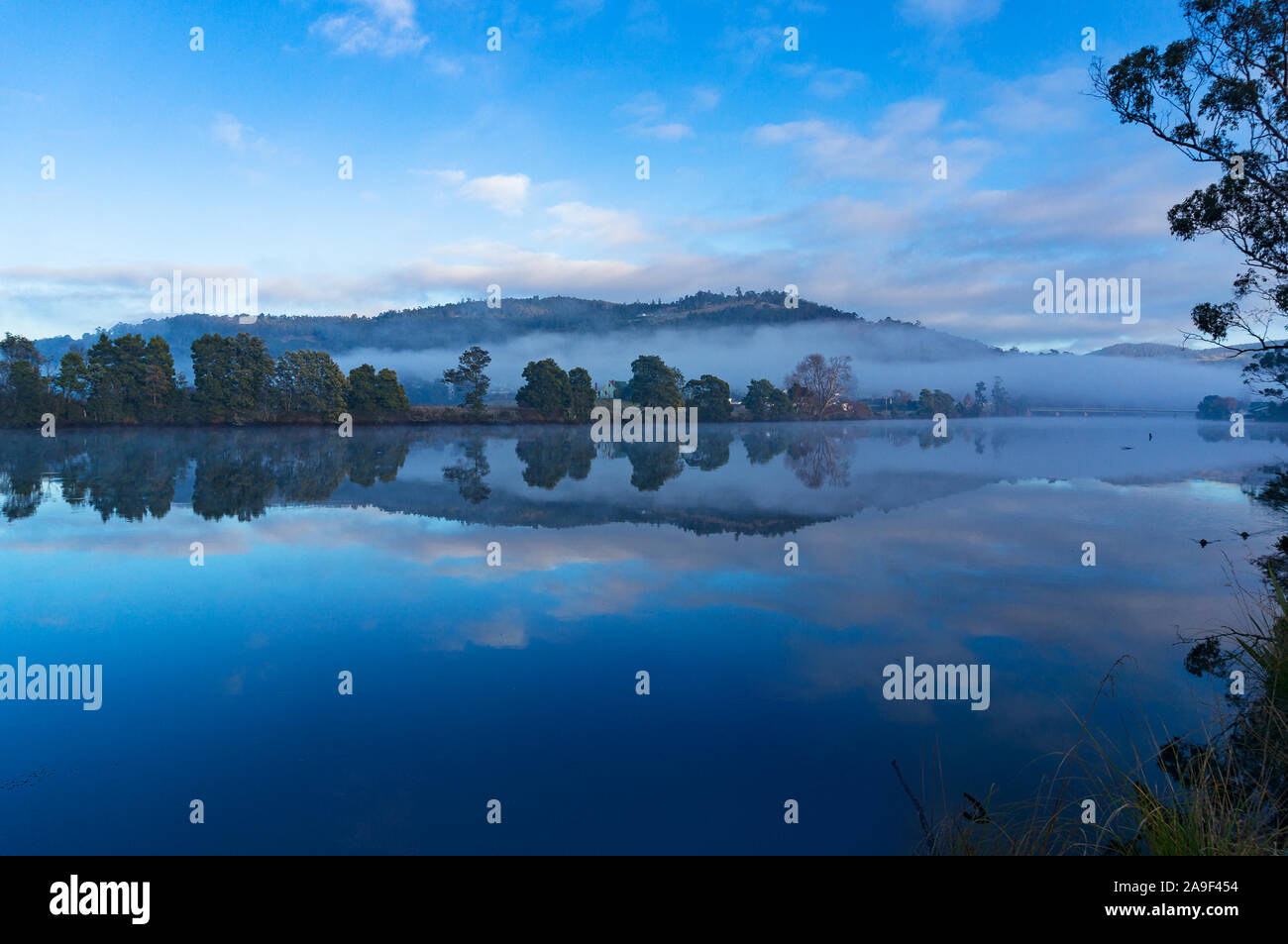 Beautiful Huon river tranquil landscape with trees and mountains ...