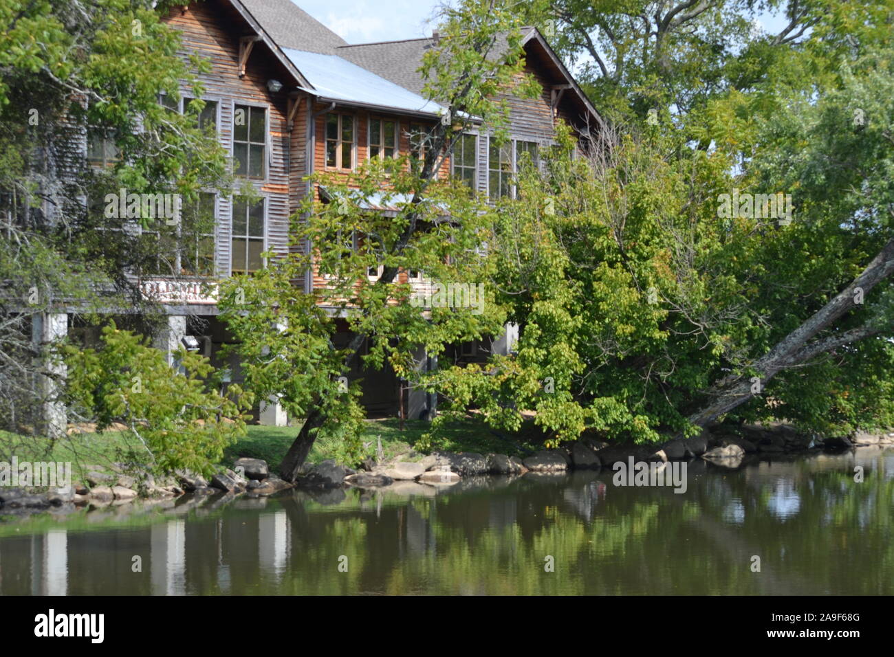 Old weather mill by stream Stock Photo - Alamy