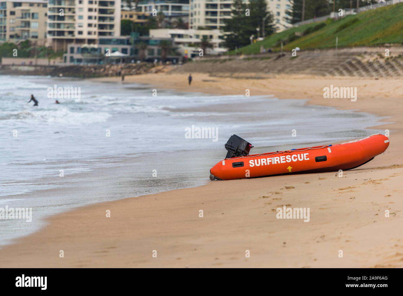 Bright orange surf saver boat on sandy beach shore. Cronulla, Australia ...