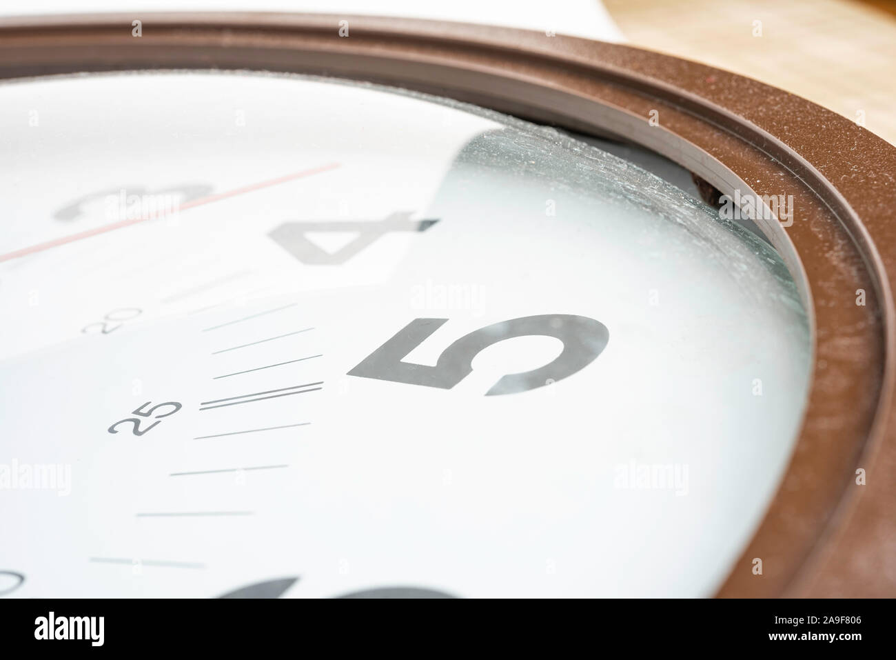 A close-up or macro shot of a broken, dirty and dusty old clock face ...