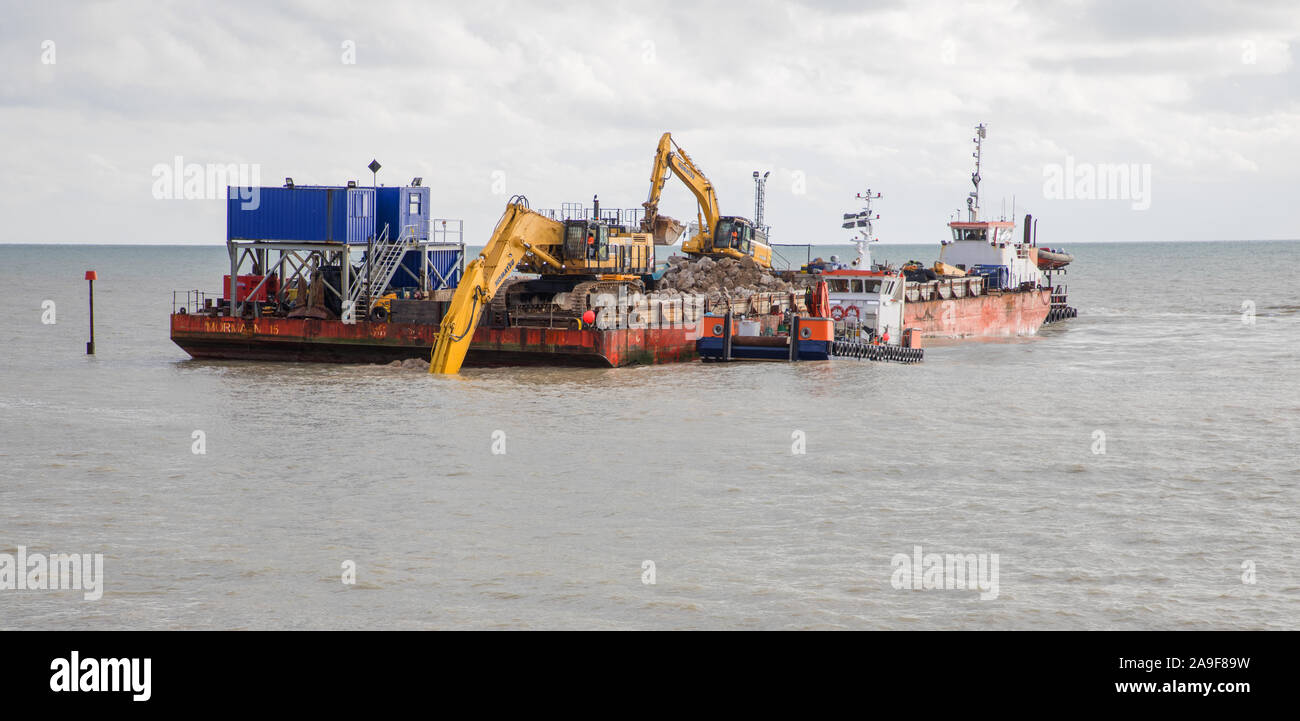rock barge delivering rocks to protect the coast from flooding at elmer ...
