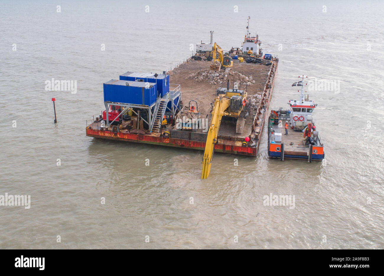 rock barge delivering rocks to protect the coast from flooding at elmer ...