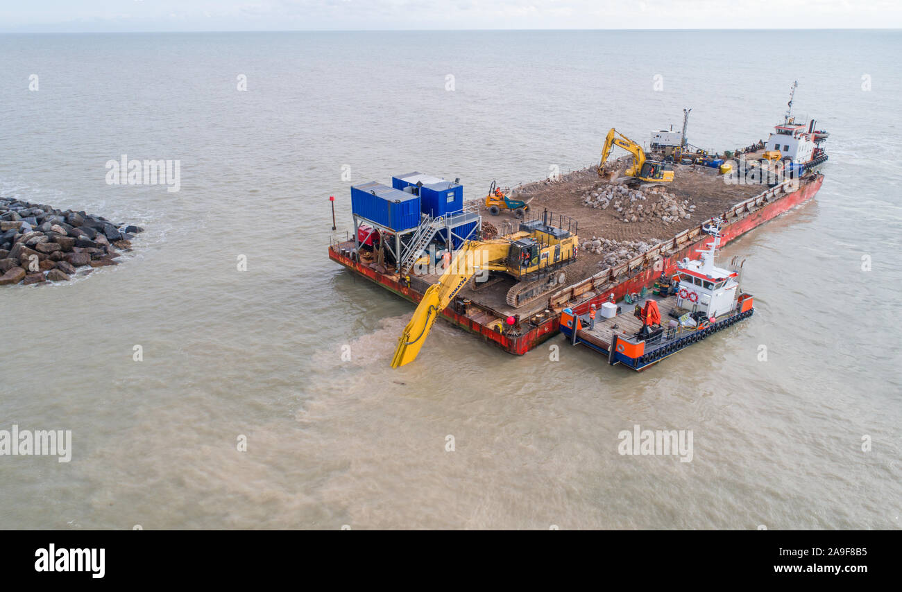 rock barge delivering rocks to protect the coast from flooding at elmer ...
