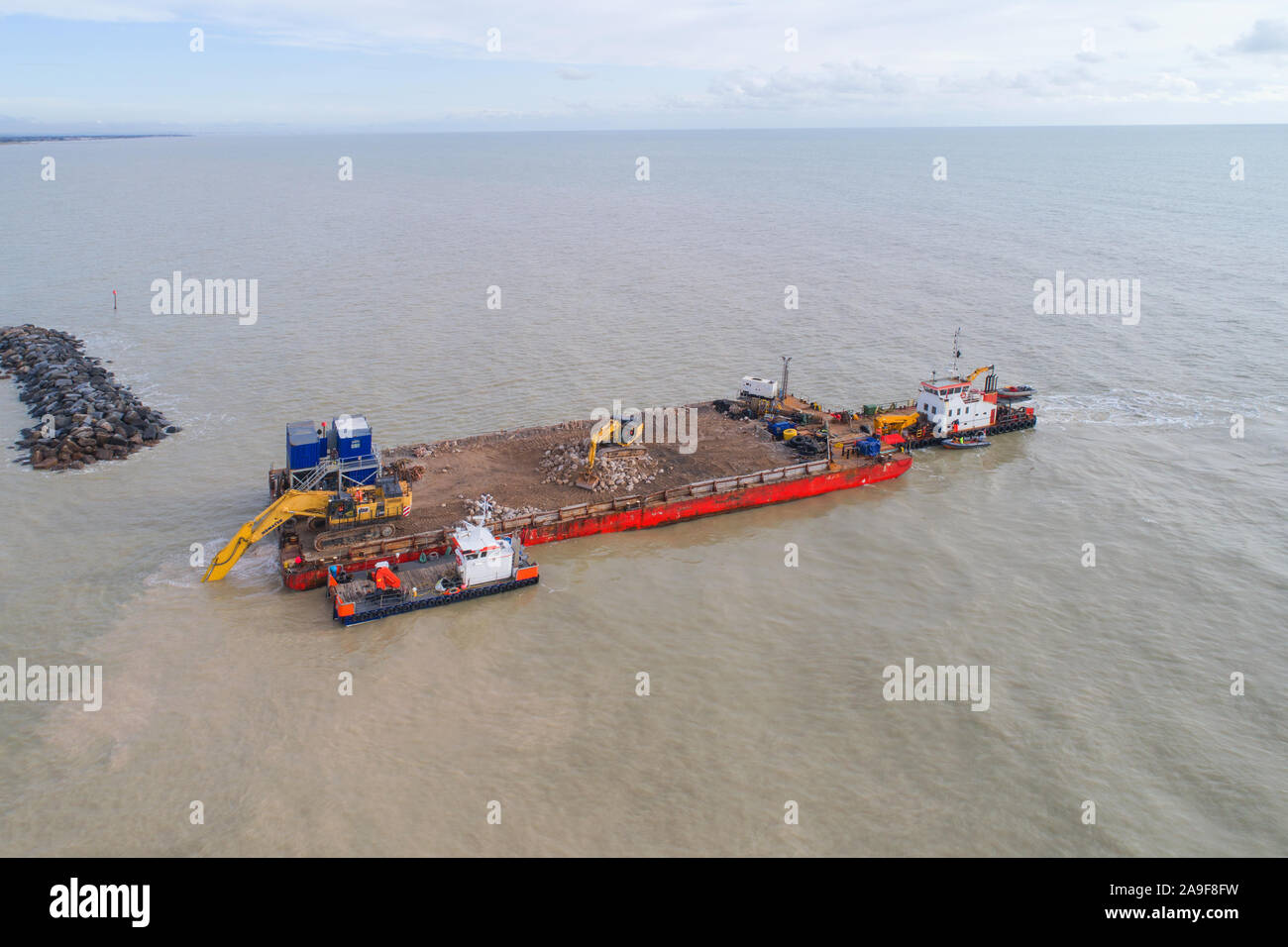 rock barge delivering rocks to protect the coast from flooding at elmer ...