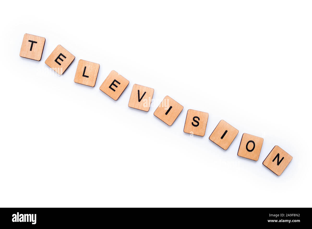 The word Television, spelt with wooden letter tiles over a white ...